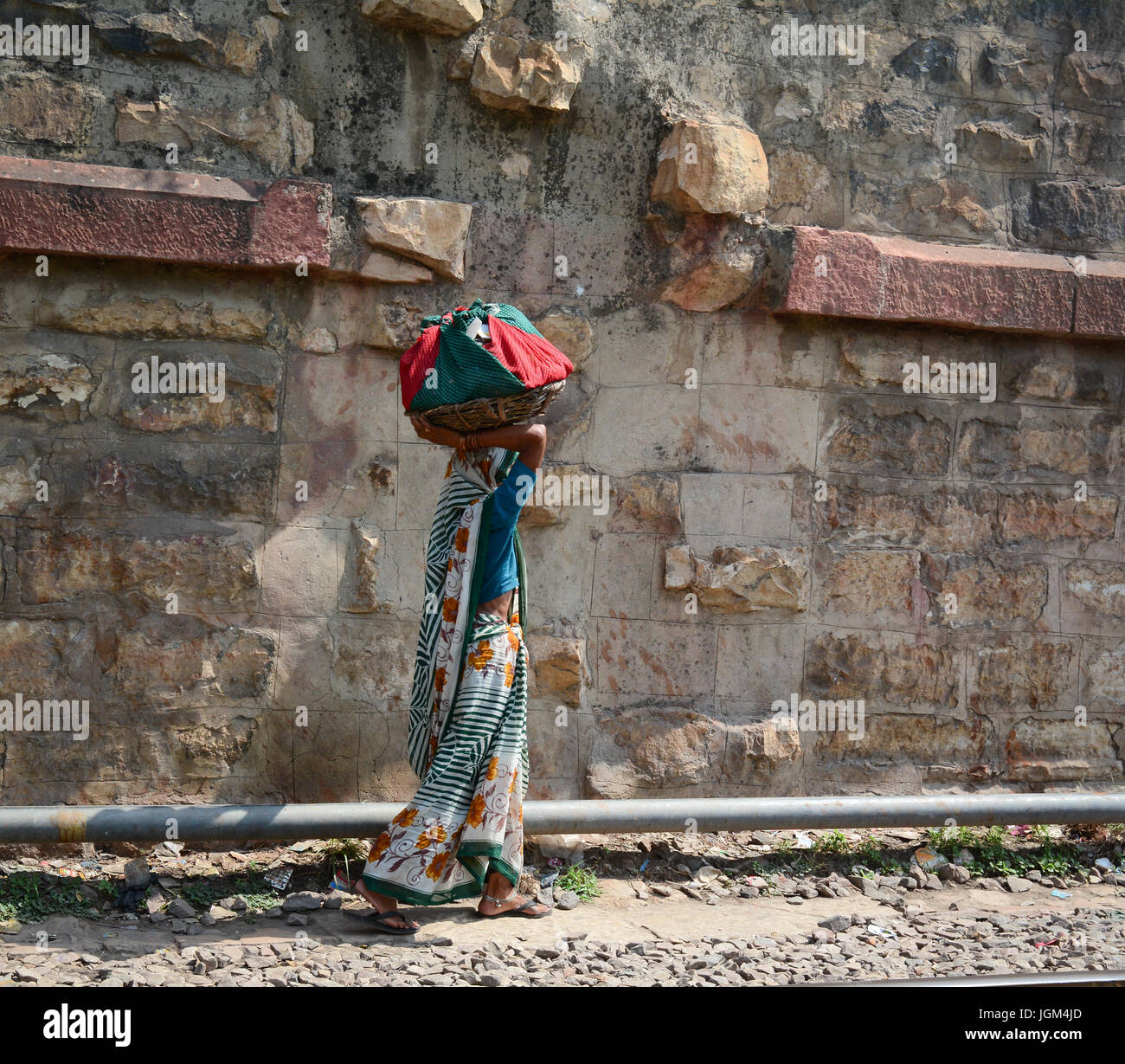 A woman walking on street in Agra, India. Agra is a major tourist ...