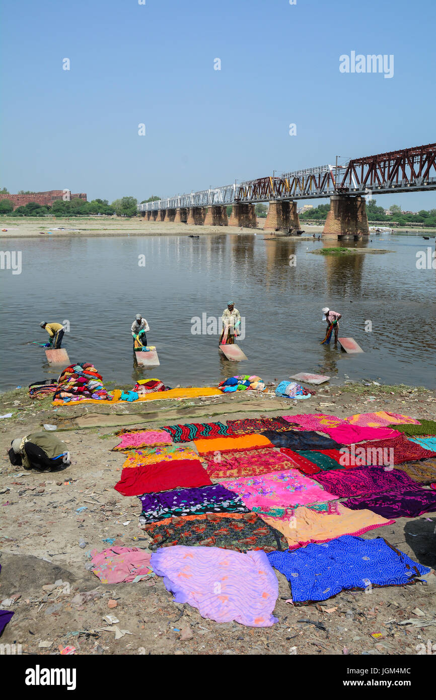 Agra, India - Jul 13, 2015. People washing clothes on the Yamuna river ...
