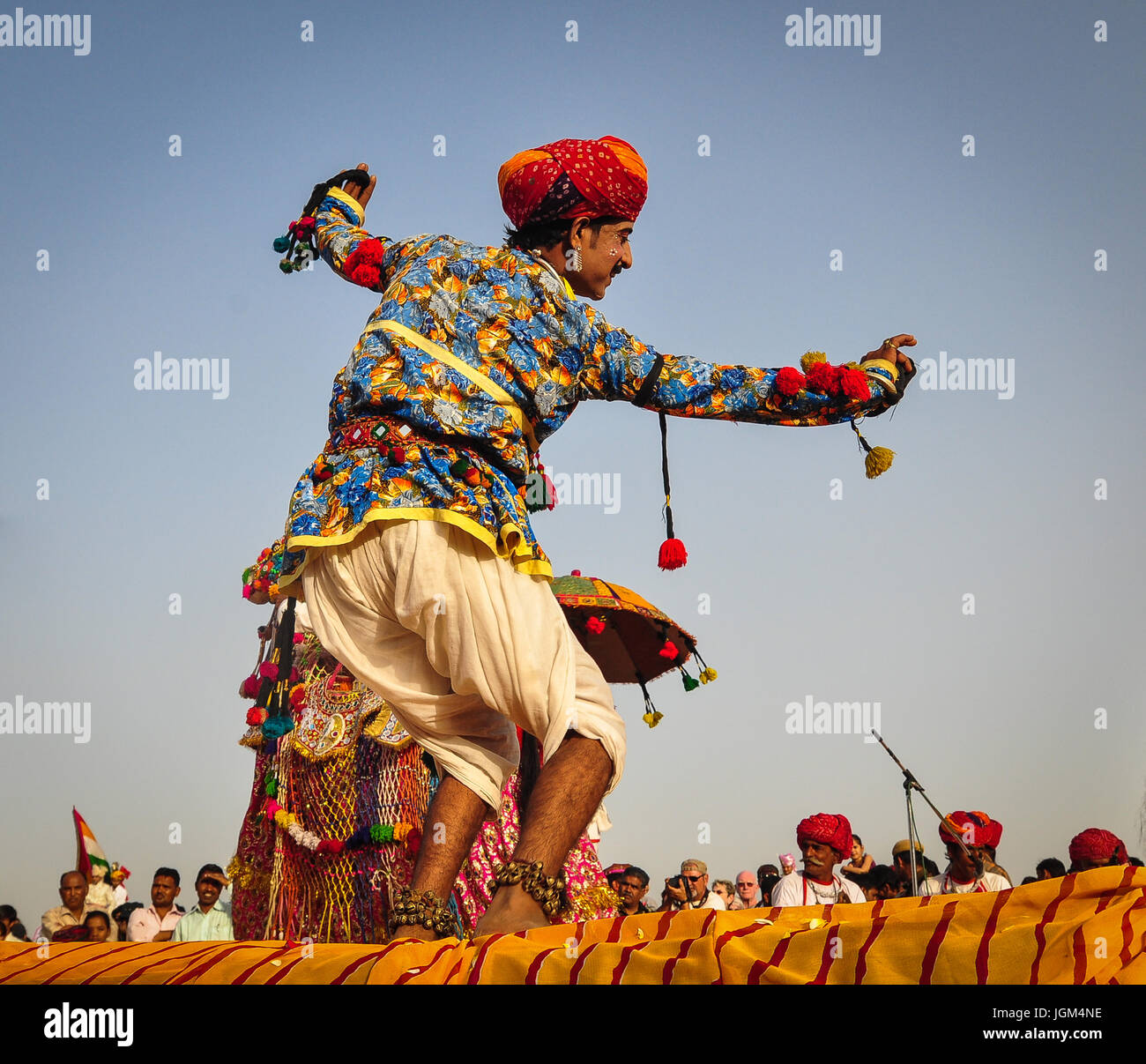 PUSHKAR, INDIA - MAR 7, 2012. Rajasthani folk dancers in colorful ...