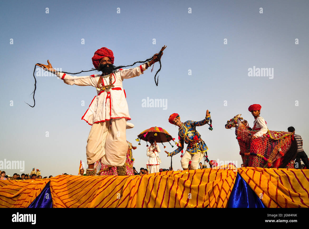 PUSHKAR, INDIA - MAR 7, 2012. Rajasthani folk dancers in colorful ...