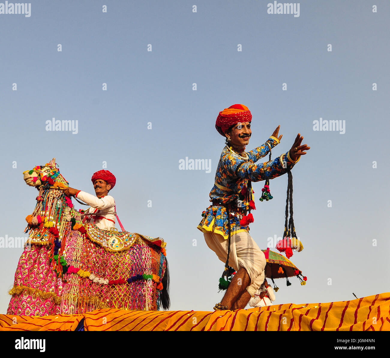PUSHKAR, INDIA - MAR 7, 2012. Rajasthani folk dancers in colorful ...