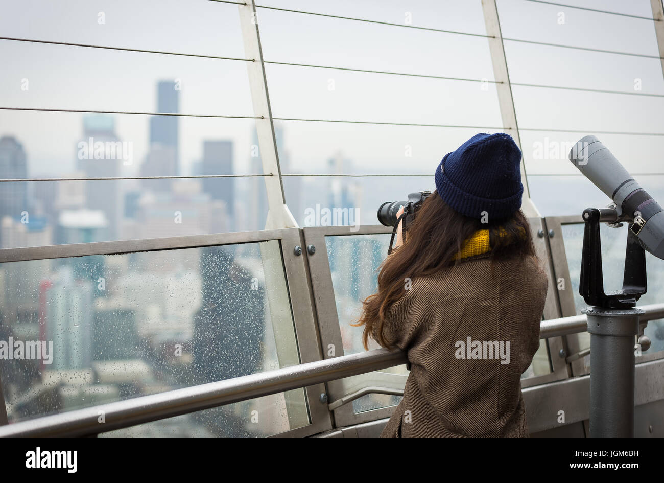 Girl taking a photo from the observation deck of the Space Needle Stock ...