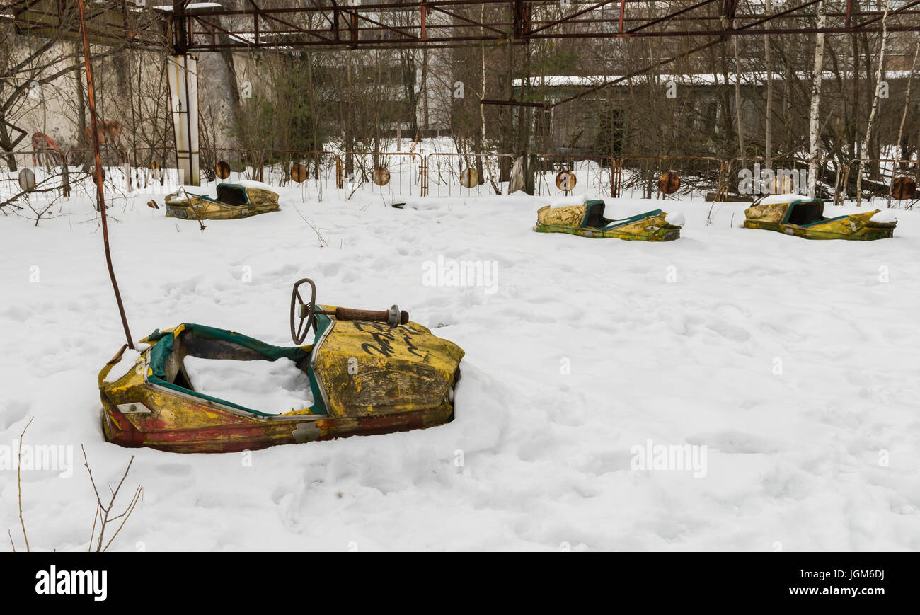 Chernobyl, Ukraine - February 19, 2017: Yellow dodgems in the snow in ...