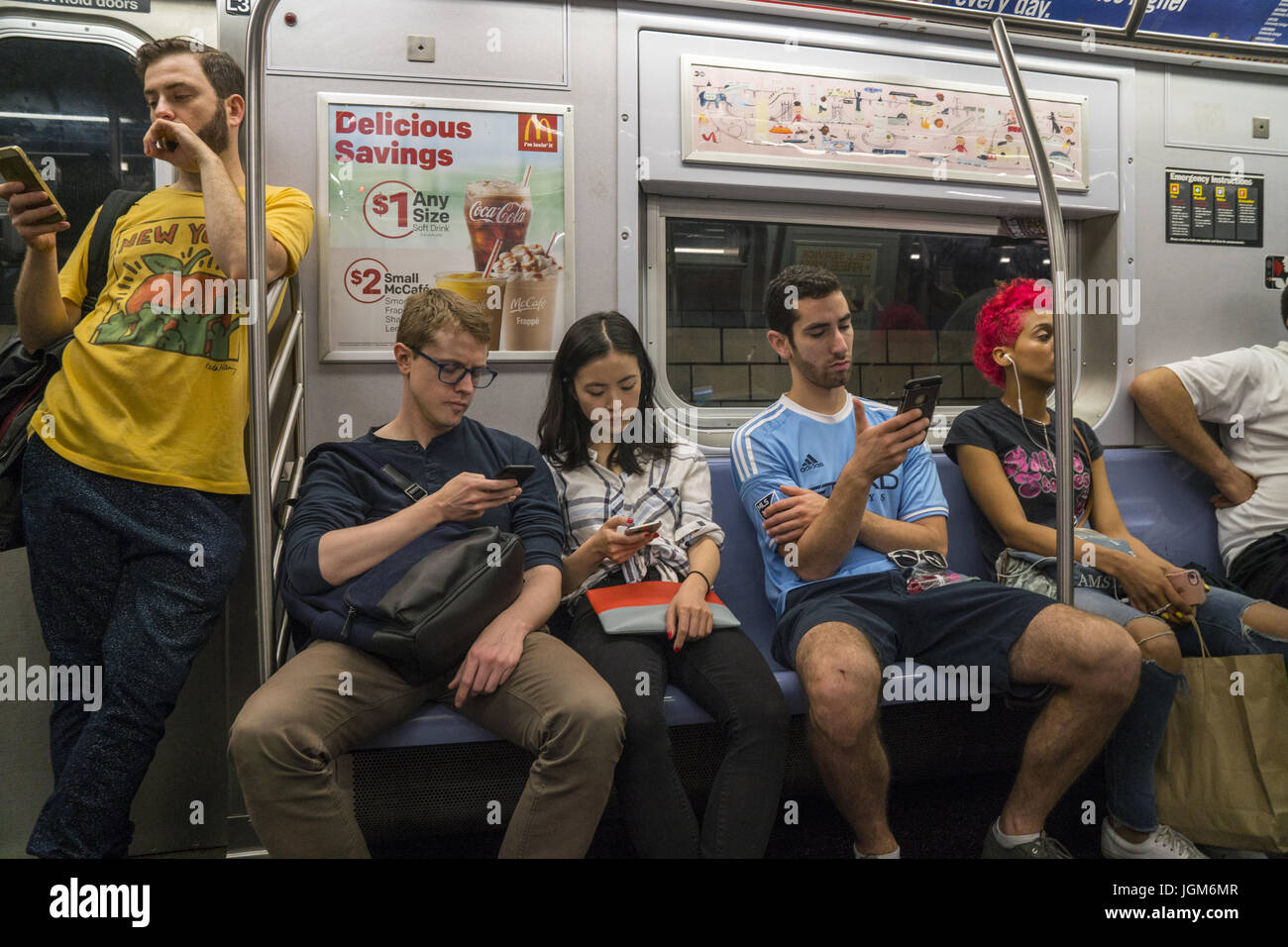 Youngish subway riders all on their phones now that the New York City ...