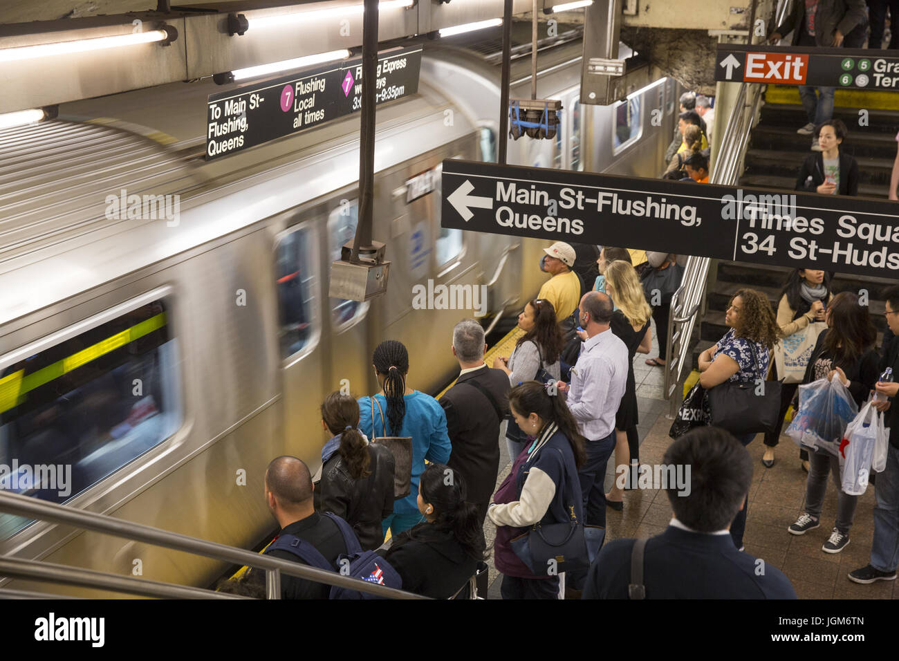 Riders wait for the 7 train at 42nd Street under Grand Central Terminal ...