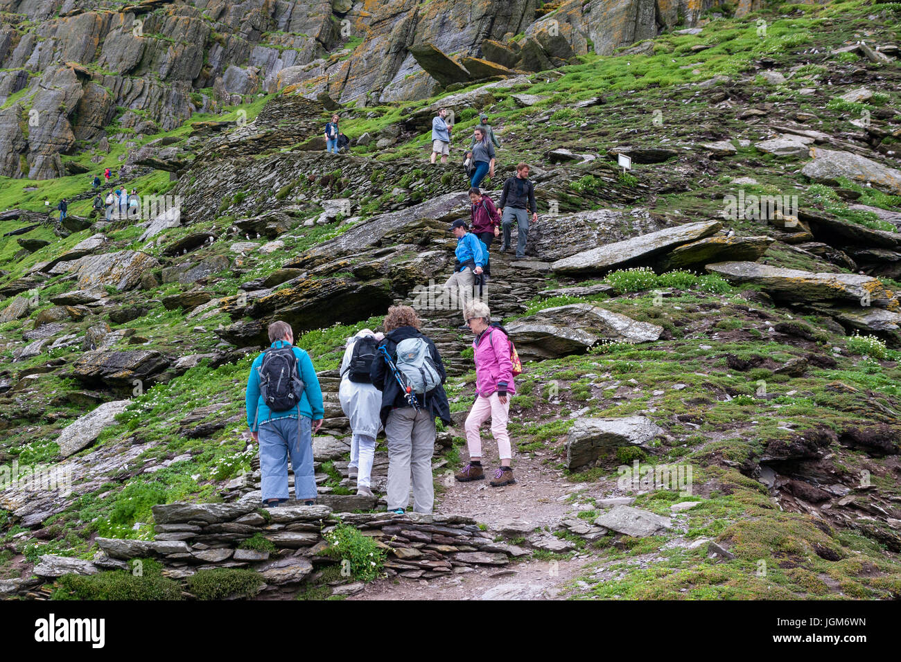 Tourists climbing stone steps on Skellig Michael, County Kerry Ireland ...