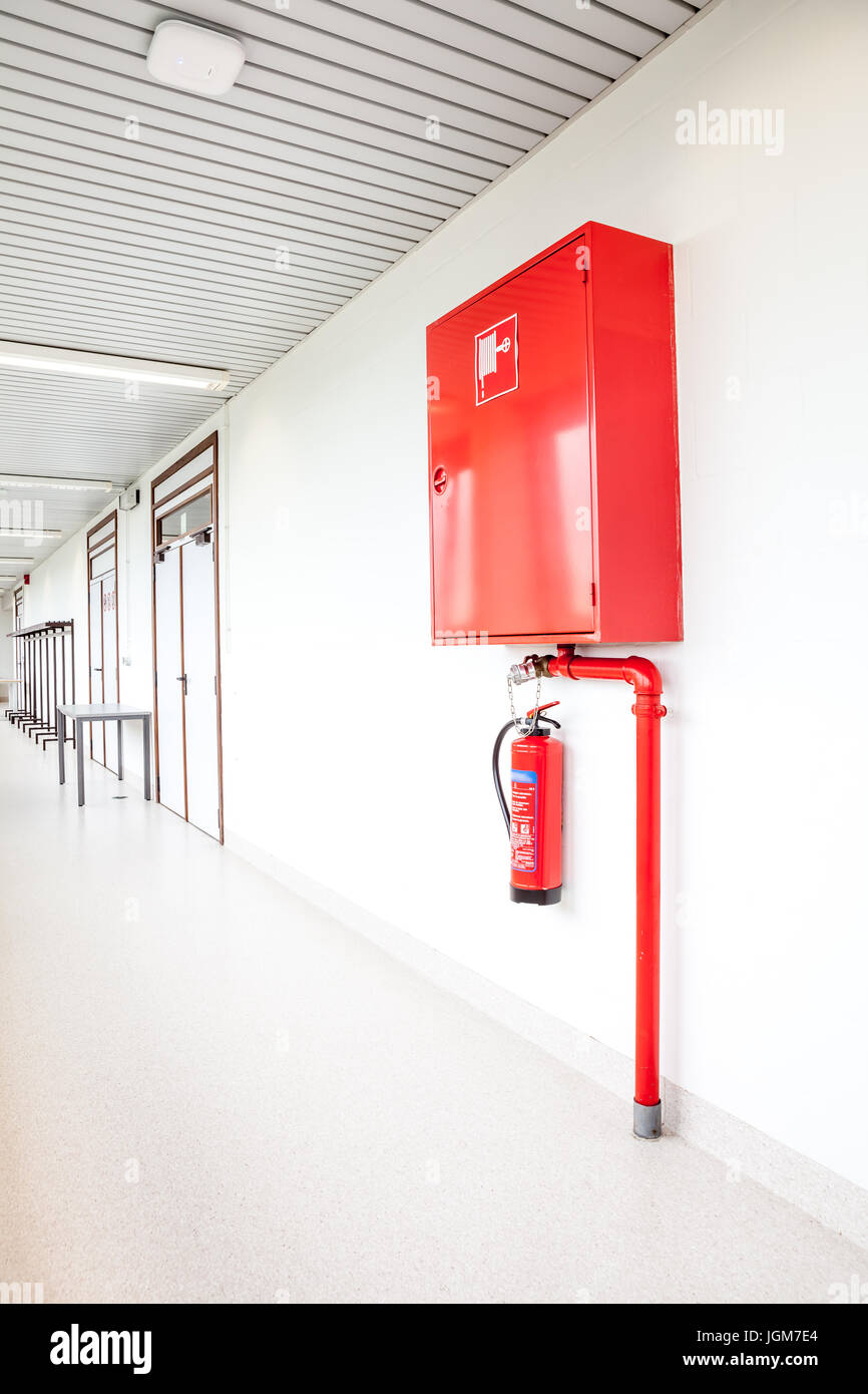 an fire hose hanging on the wall in an staircase Stock Photo - Alamy