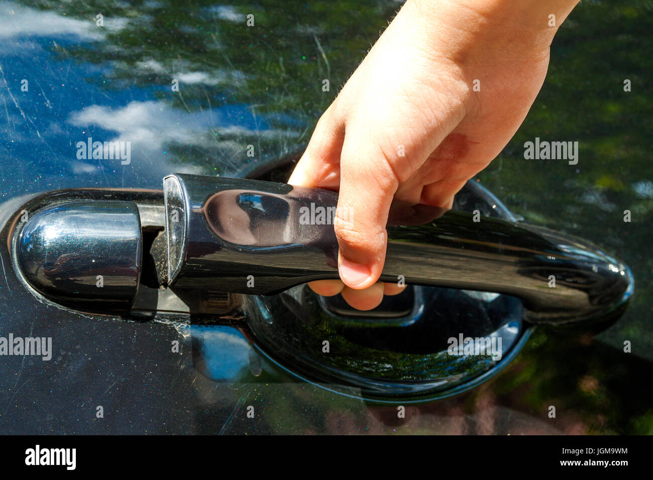 Close up of human child hand opening car door Stock Photo - Alamy