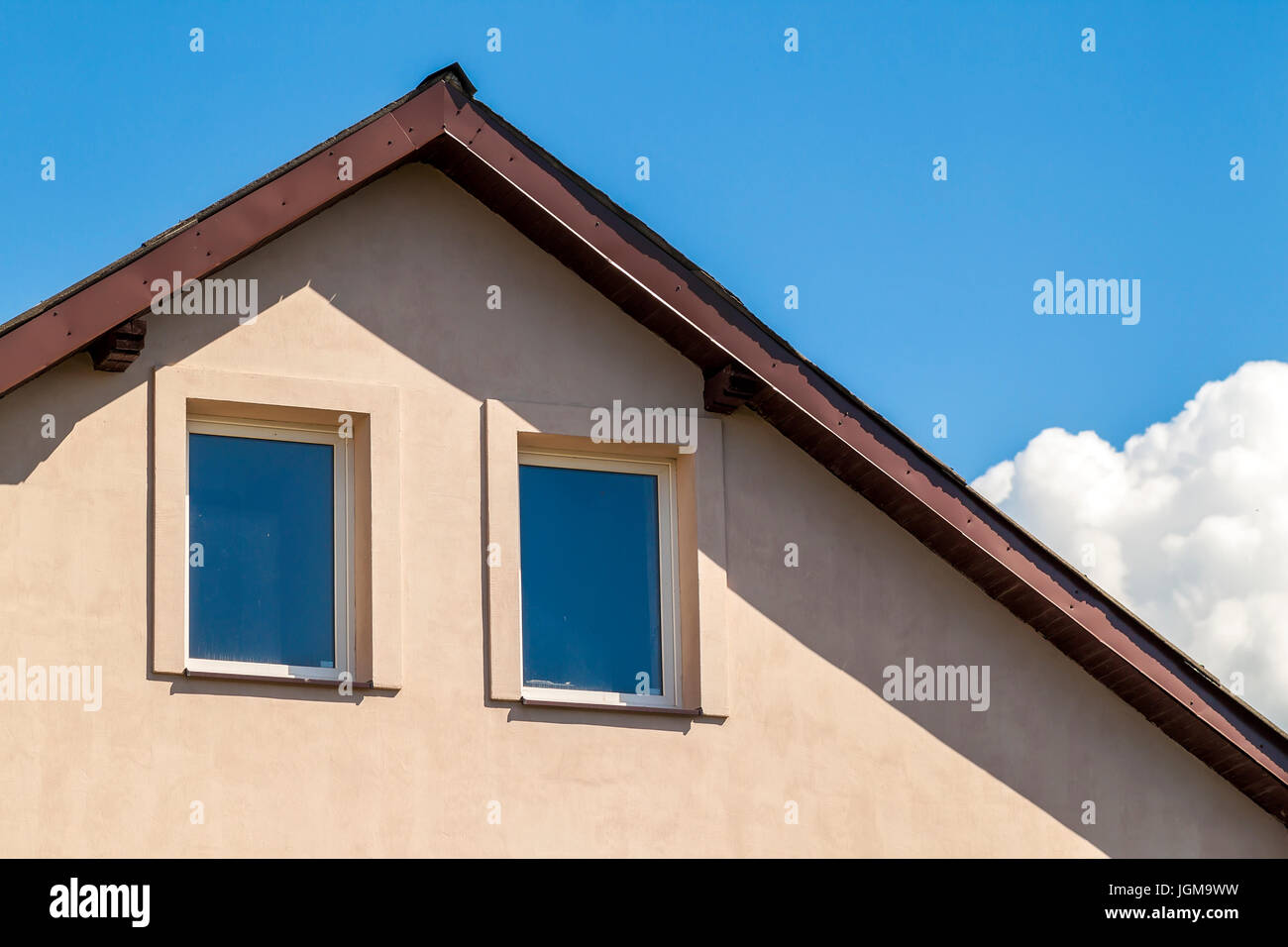 Close up of top windows under roof in house Stock Photo - Alamy
