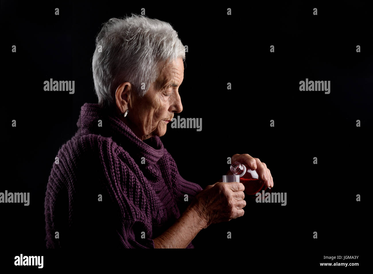 Old woman taking syrup Stock Photo - Alamy