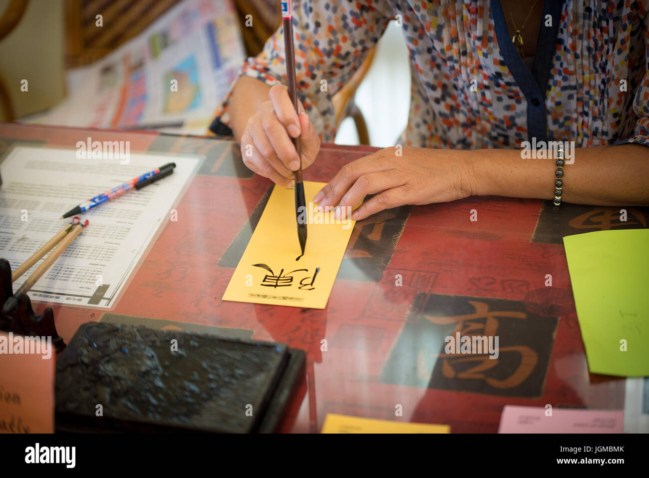 Calligraphy demonstration at a festival Stock Photo - Alamy
