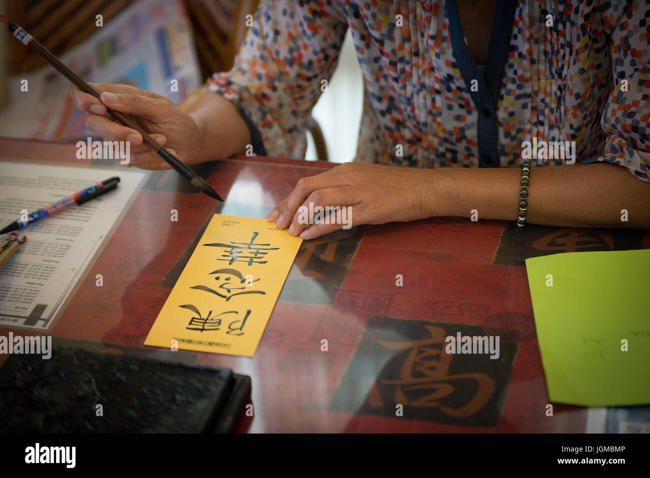 Calligraphy demonstration at a festival Stock Photo - Alamy