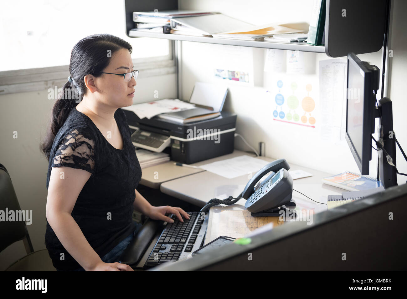 Girl focusing on computer work Stock Photo - Alamy