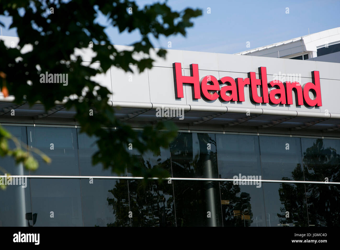 A logo sign outside of a facility occupied by Heartland Payment Systems ...