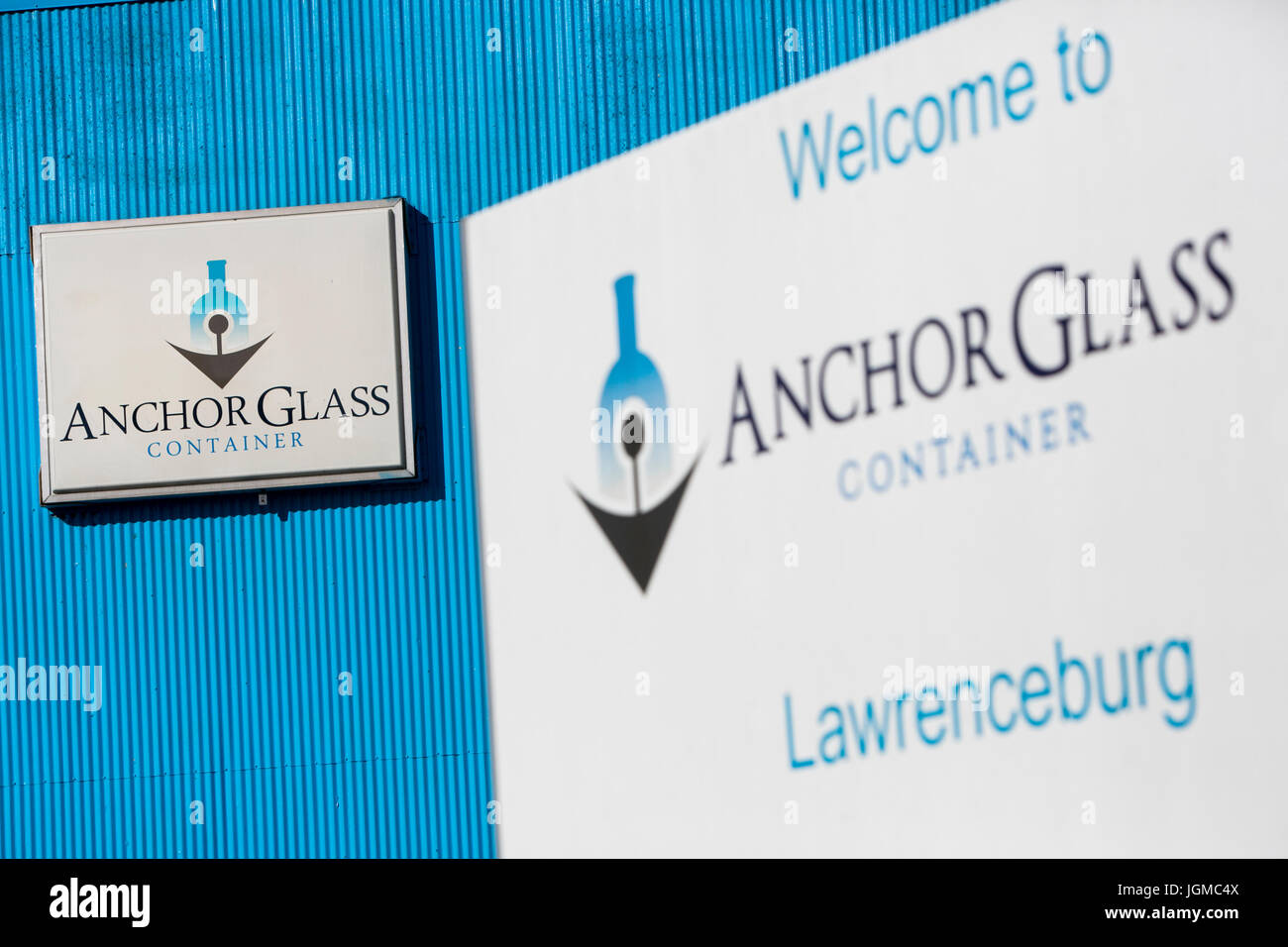 A logo sign outside of a facility occupied by Anchor Glass Container ...