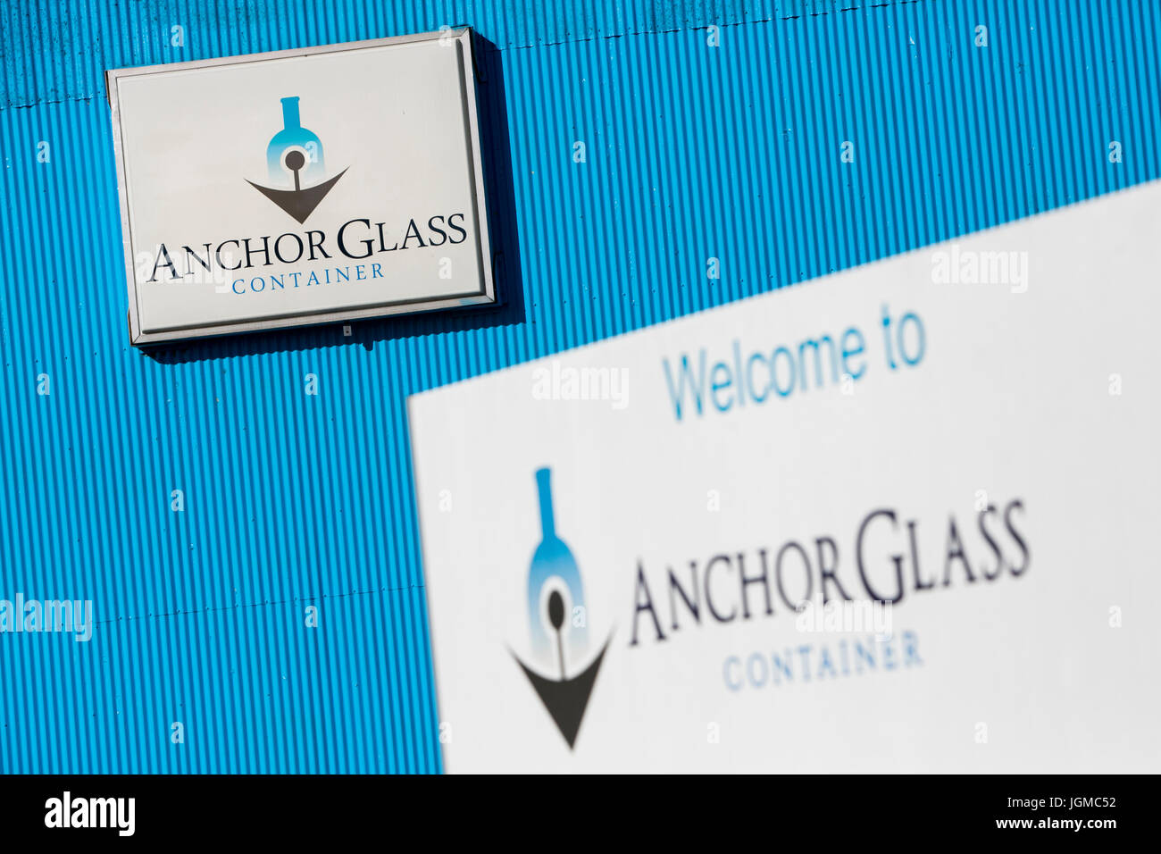 A logo sign outside of a facility occupied by Anchor Glass Container ...