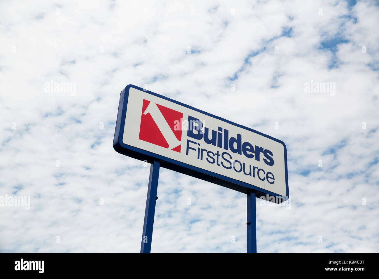 A logo sign outside of a facility occupied by Builders FirstSource, Inc ...