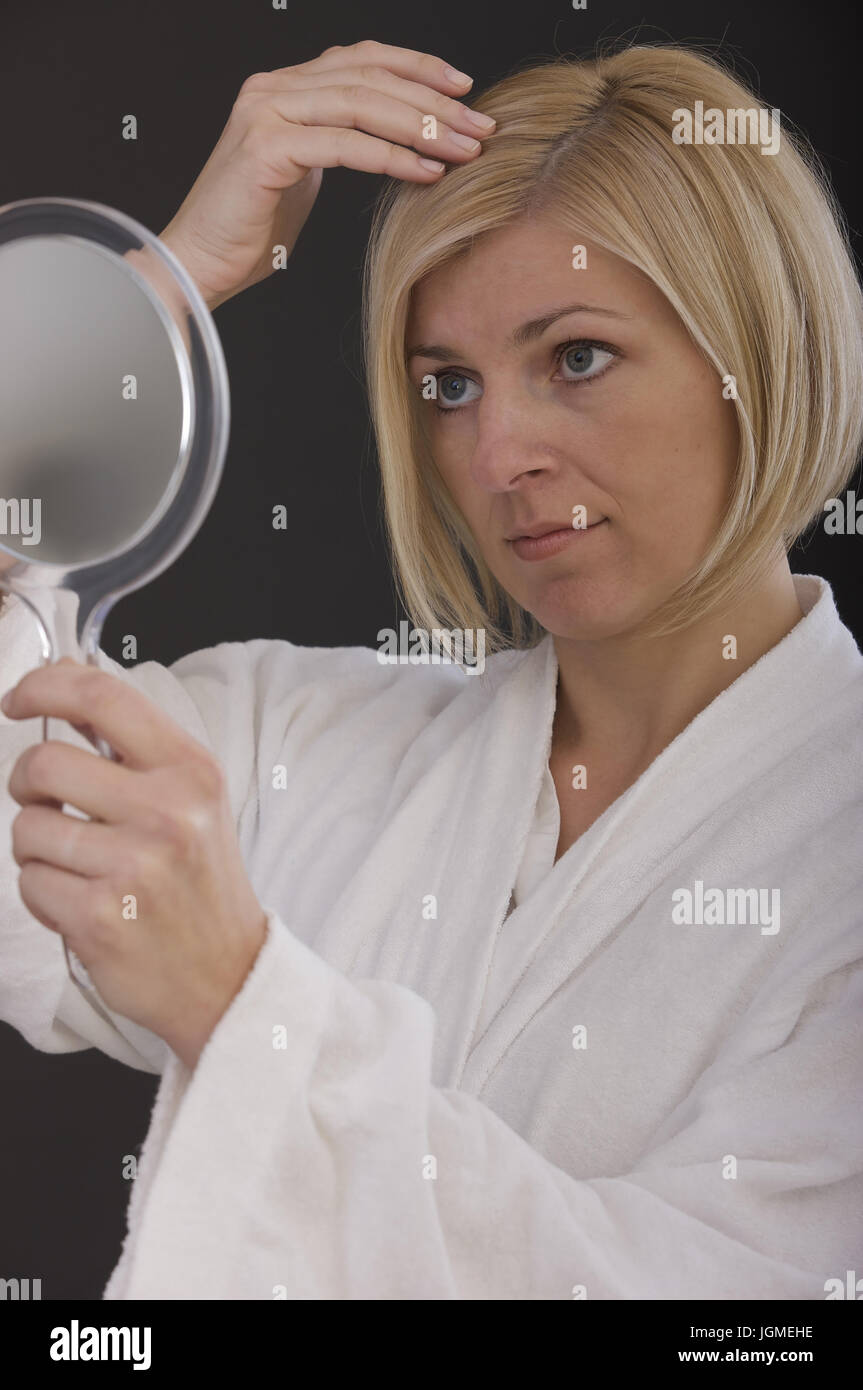 Woman looks in the mirror - woman look into the mirror, Frau schaut in ...