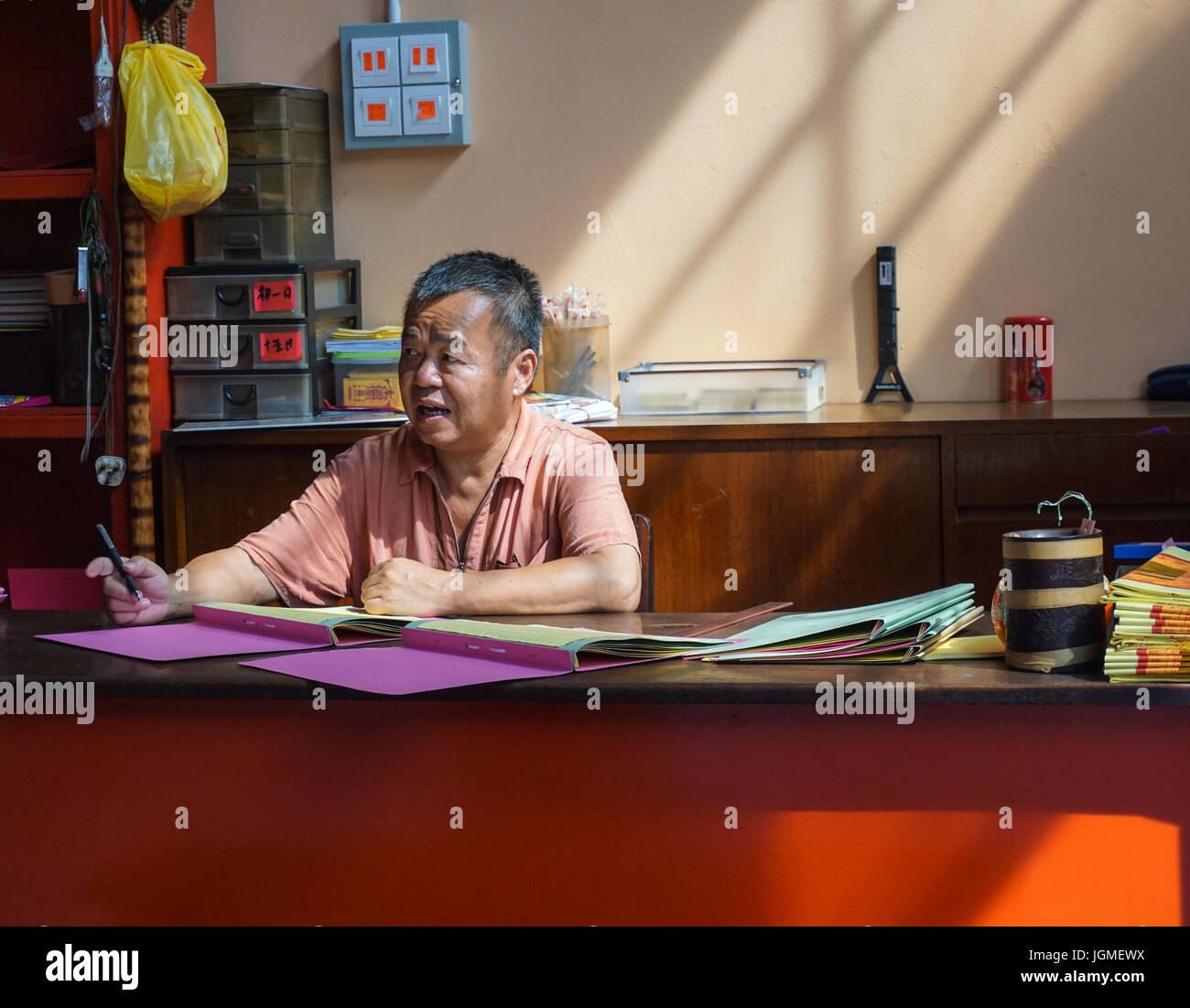 Kuala Lumpur, Malaysia - Jun 6, 2015. A man sitting at Chinese temple ...