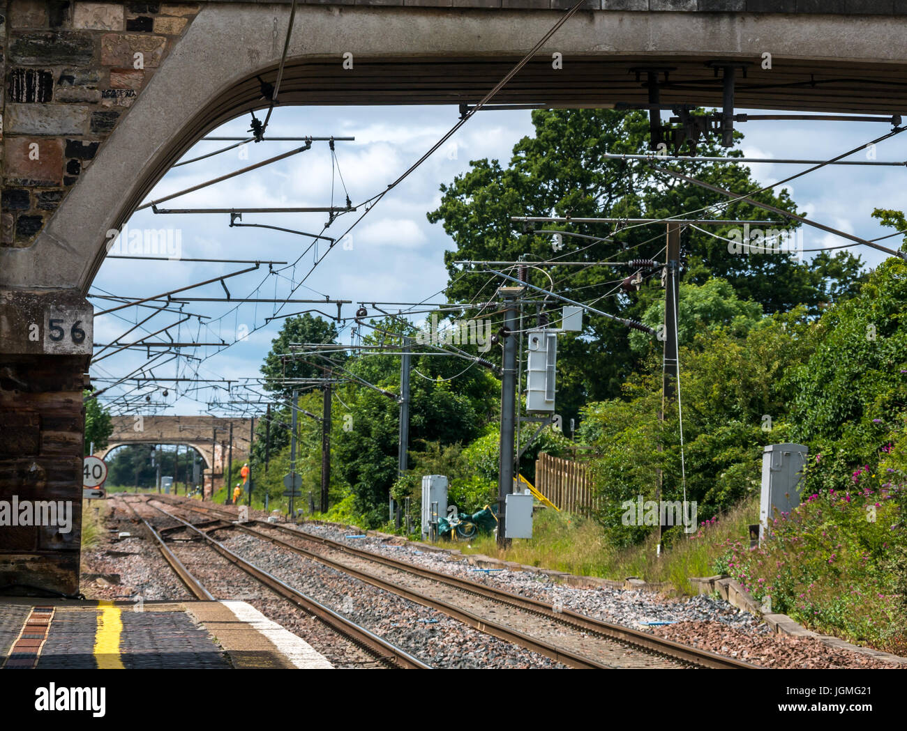 Looking through small stone bridge along railway train tracks, Drem ...