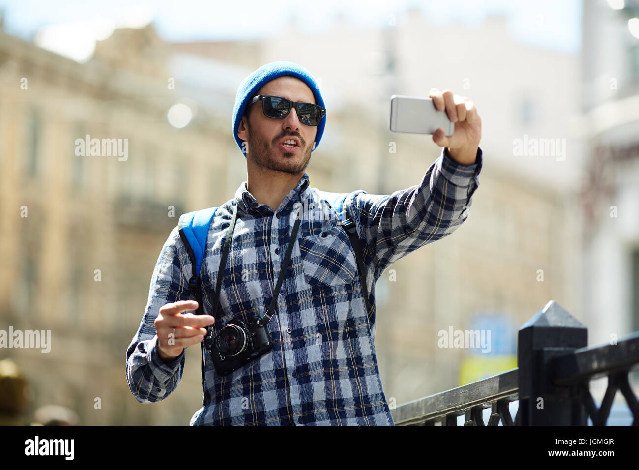 Young man making selfie while having walk in the city Stock Photo - Alamy
