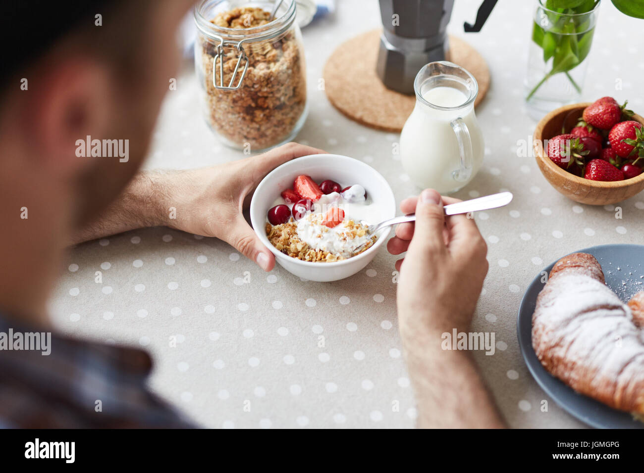 Hungry man eating breakfast consisting of healthy food Stock Photo - Alamy