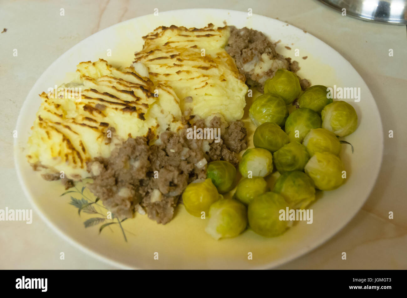 A home made Shepherd's pie with steamed Brussels sprouts Stock Photo ...