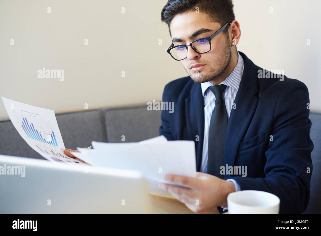 Serious leader reading new contract in office Stock Photo - Alamy