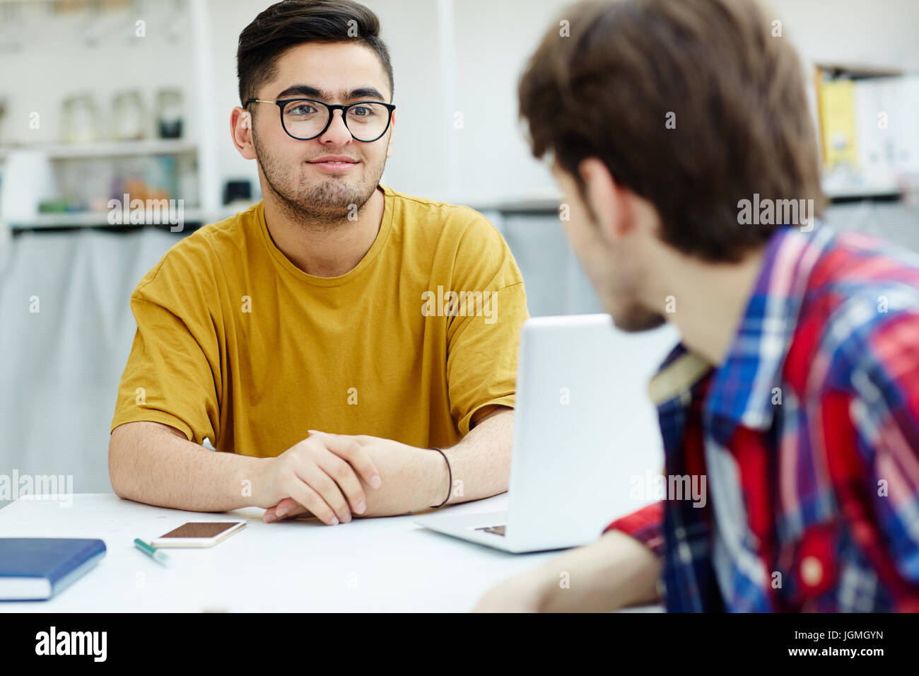 Guy listening to groupmate during conversation Stock Photo - Alamy