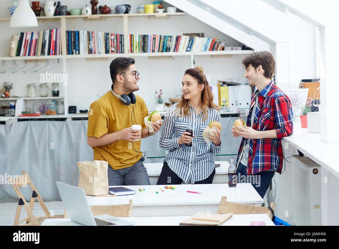 Group of friends talking while having snack at break Stock Photo - Alamy