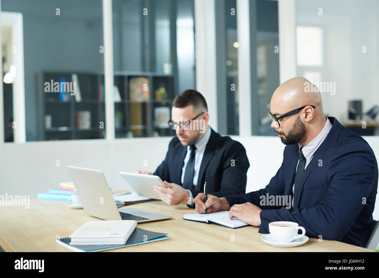Small group of businessmen planning work in office Stock Photo - Alamy