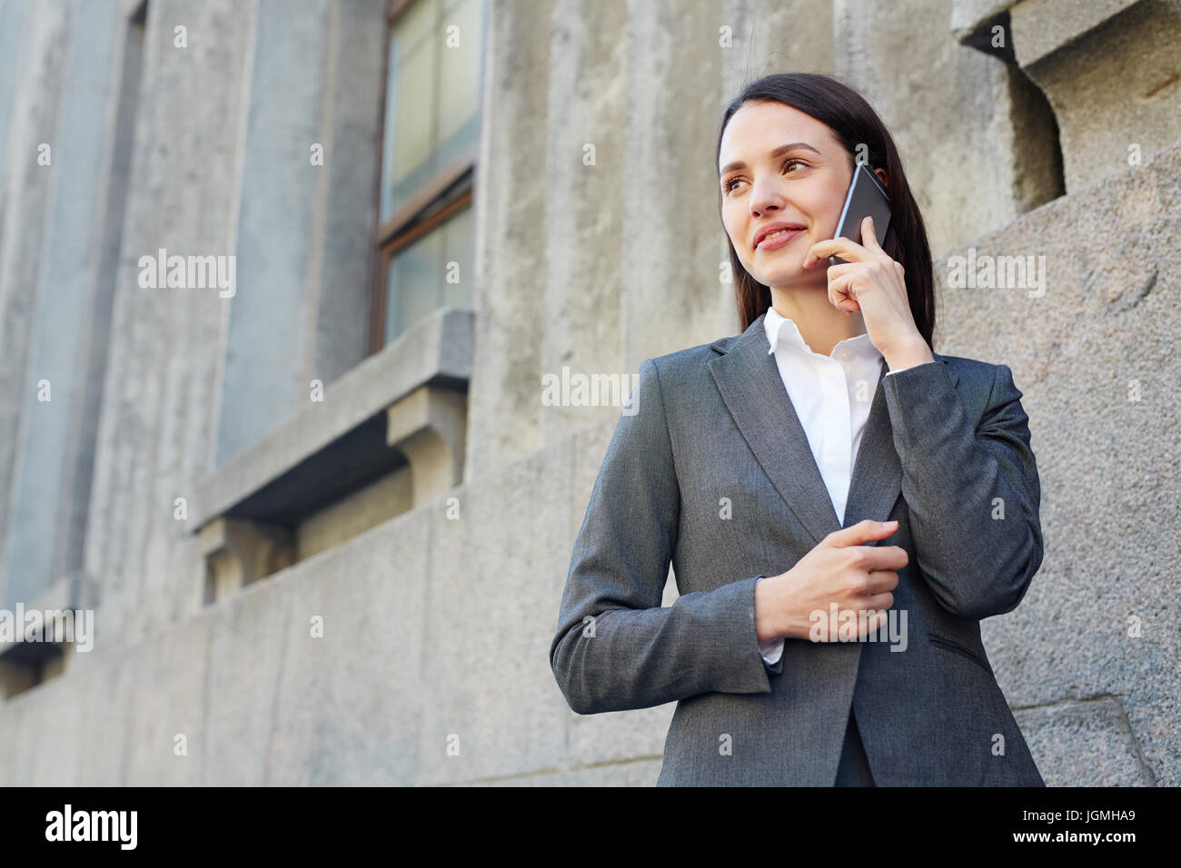 Young agent speaking by smartphone outdoors Stock Photo - Alamy
