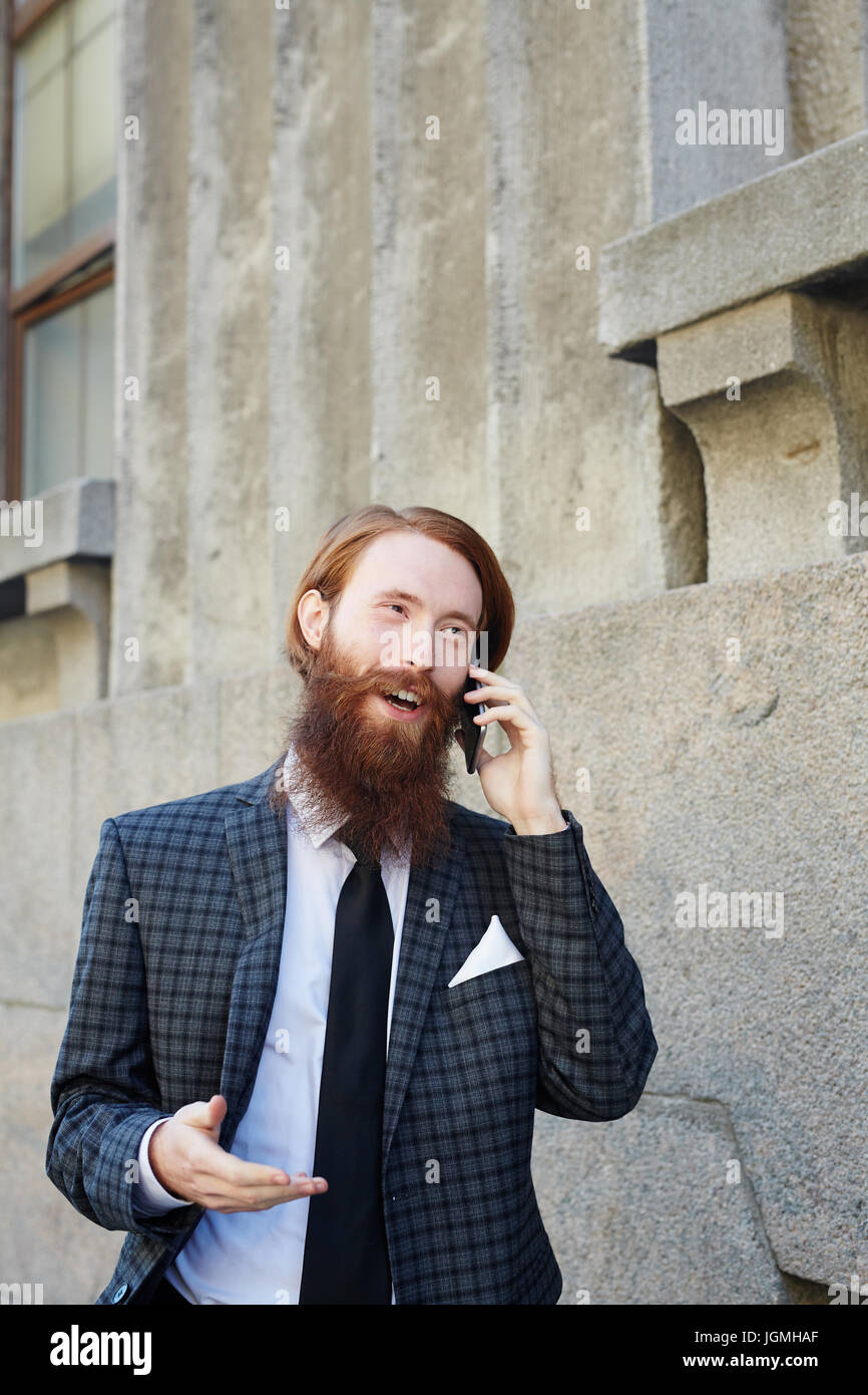 Mobile businessman consulting one of clients by phone Stock Photo - Alamy