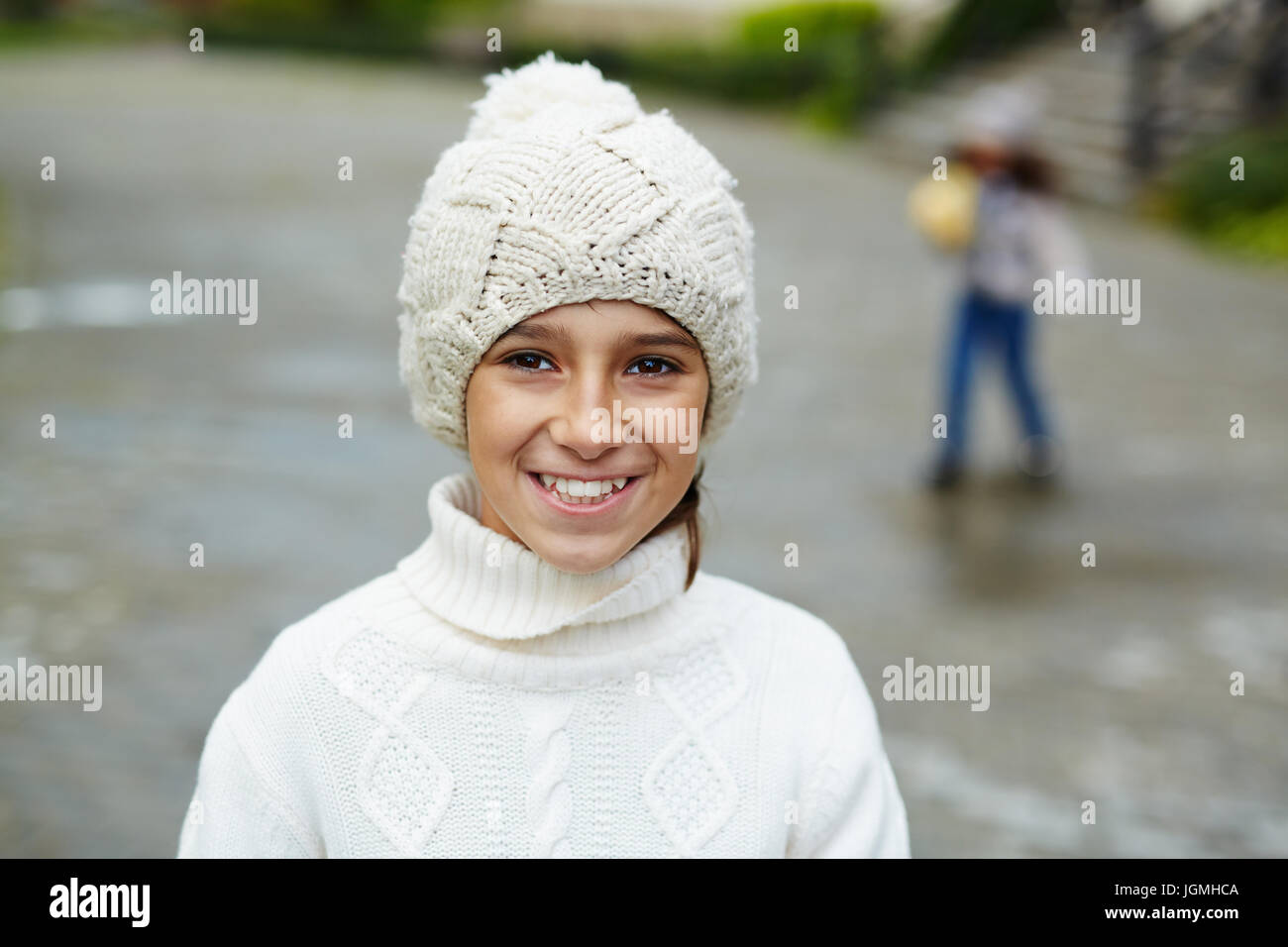 Portrait of tan skinned teenage boy smiling looking at camera while ...