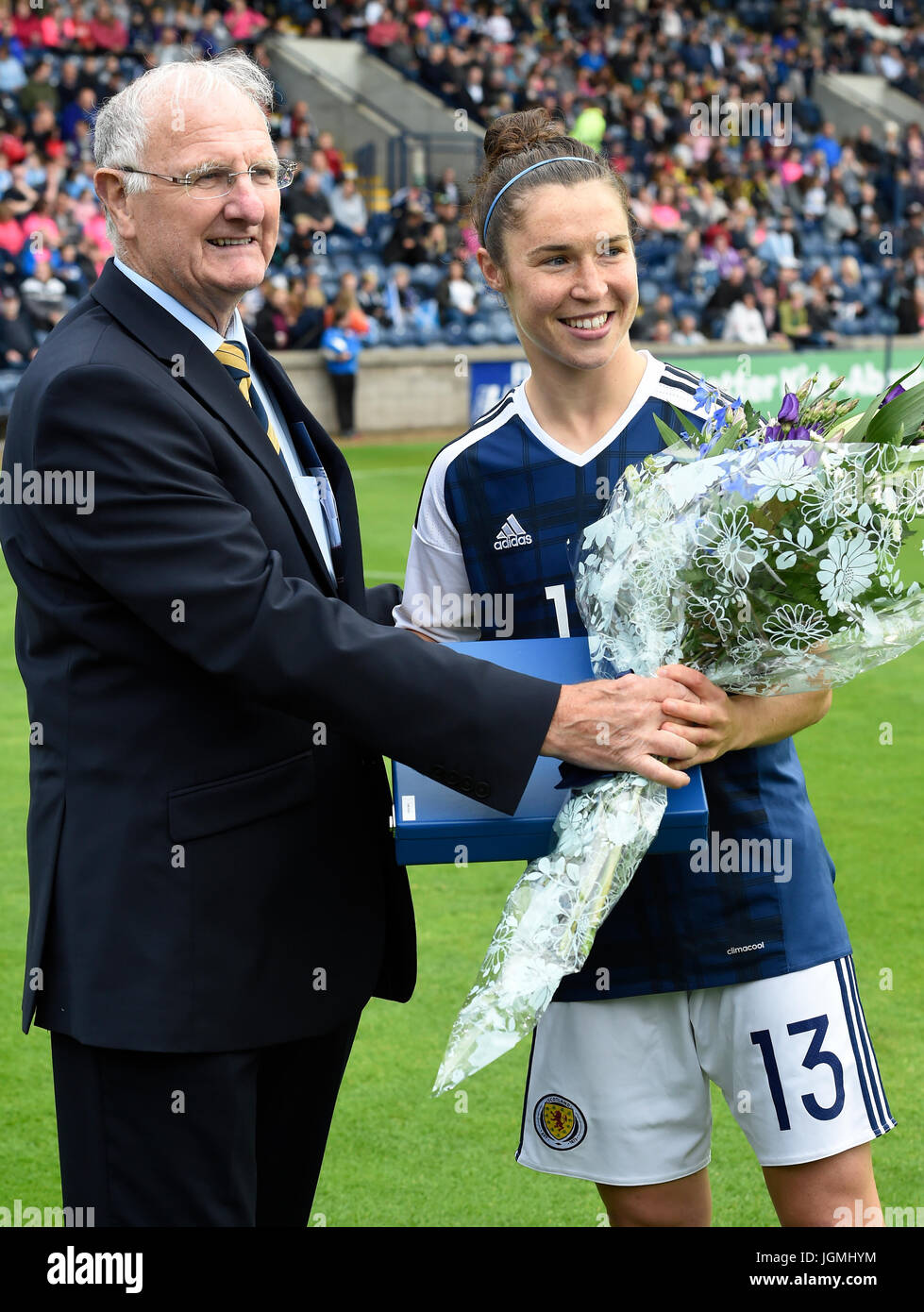 Scotland's Jane Ross is presented with flowers to mark her 100th cap ...