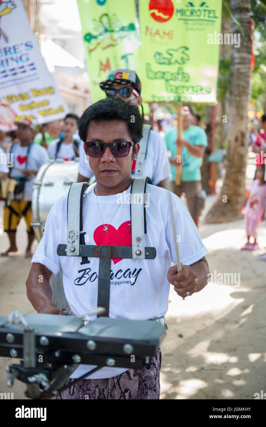 Vertical picture of a man playing music in Ati-Atihan Festival at White ...