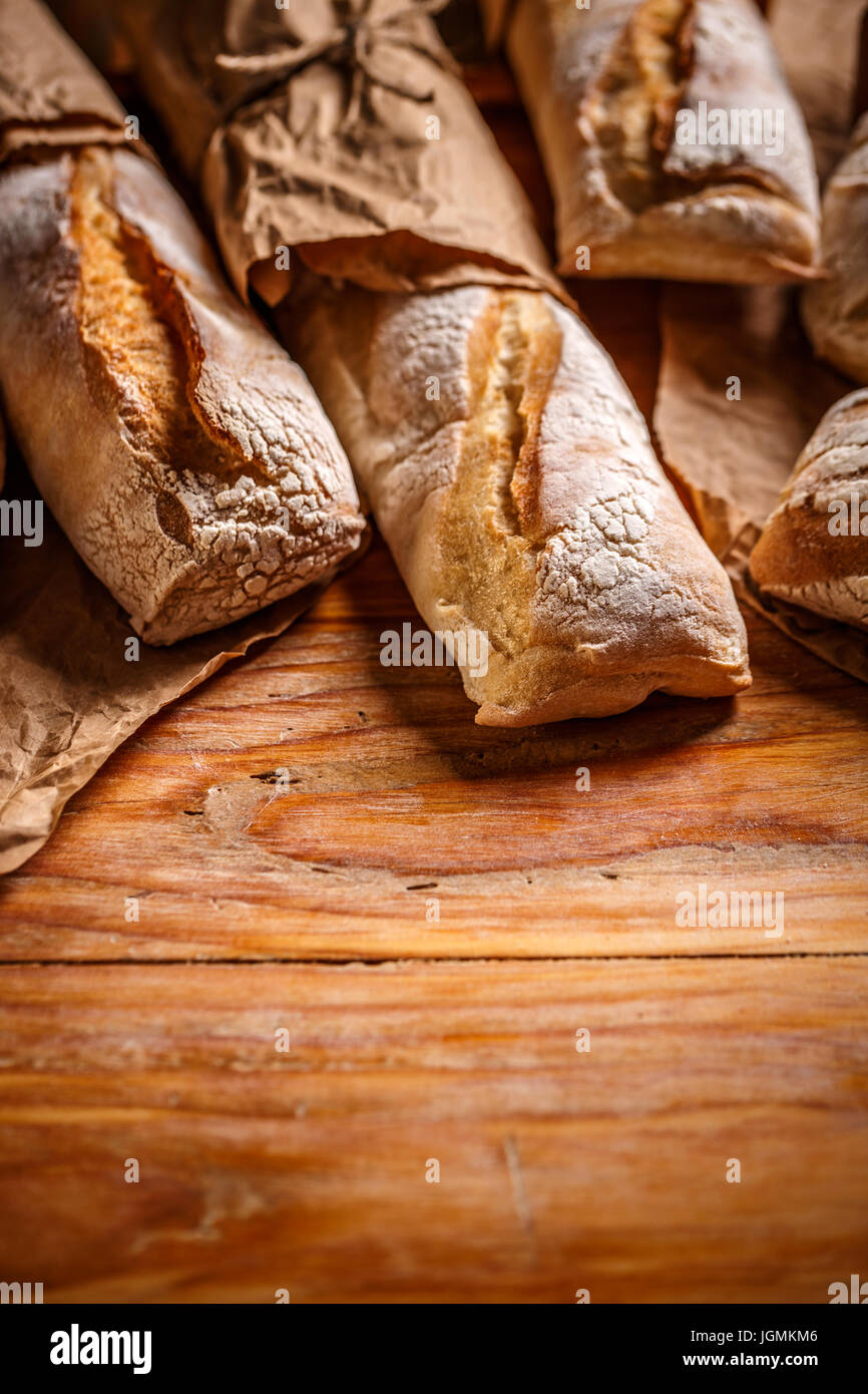 French bread baguettes on rustic wooden background Stock Photo - Alamy