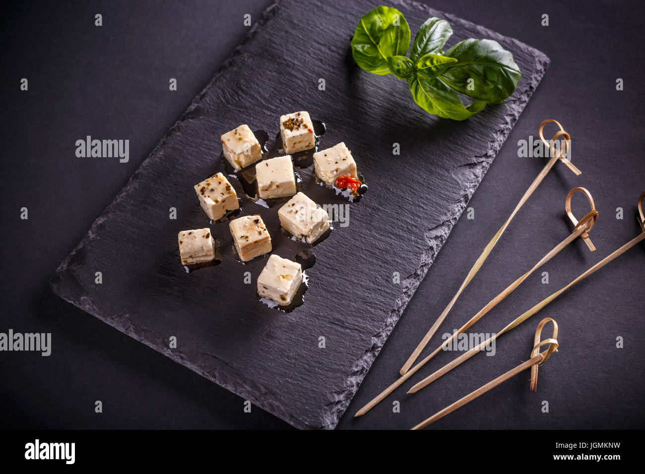 Tasty spice cheese served on black slate Stock Photo - Alamy