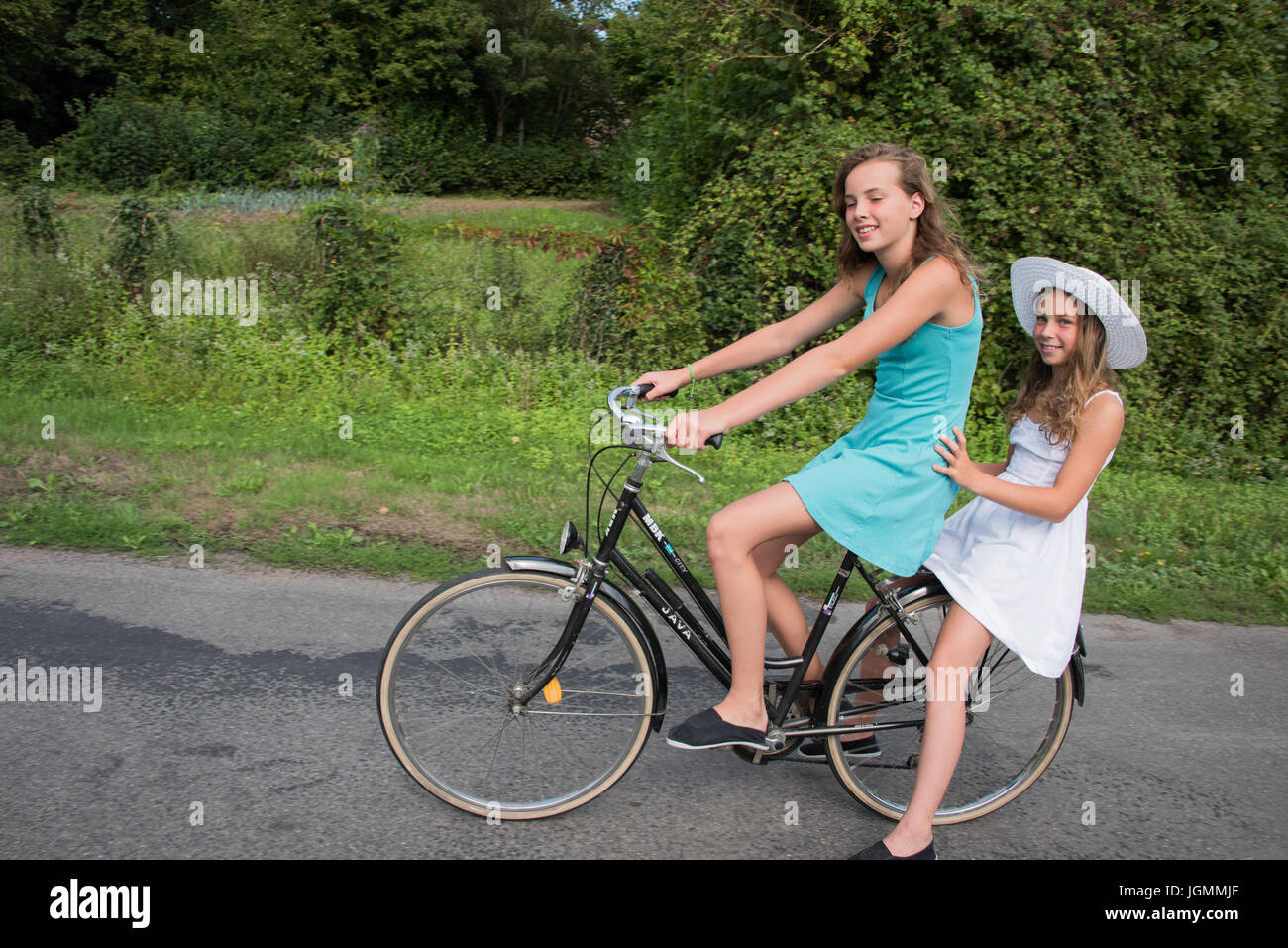 Two girls on a bike hi-res stock photography and images - Alamy