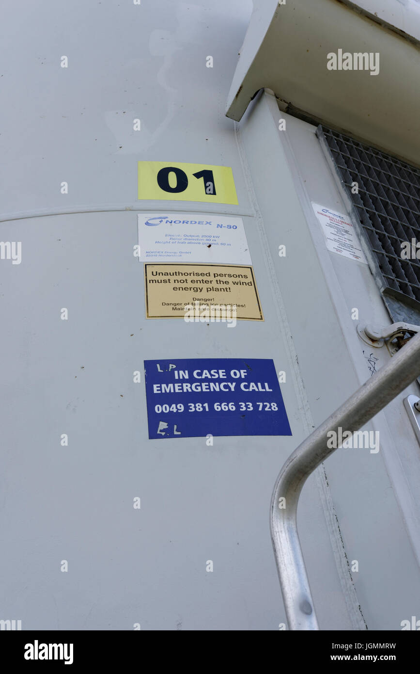 Emergency telephone number warning notice and 01 notice at base of wind ...