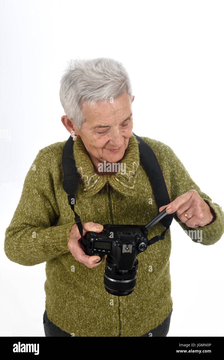 older woman looking at a picture on the screen of the camera Stock ...