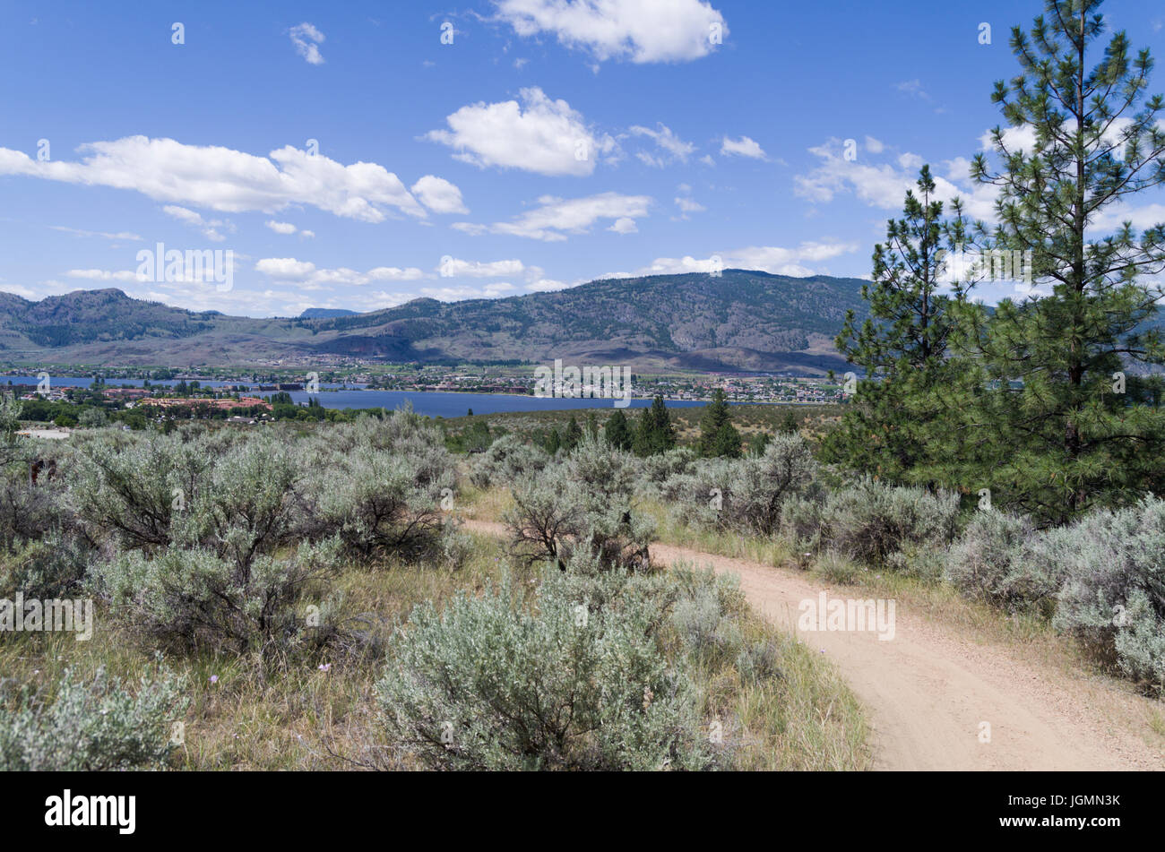 Desert landscape with Spirit Ridge resort buildings and Lake Osoyoos in ...