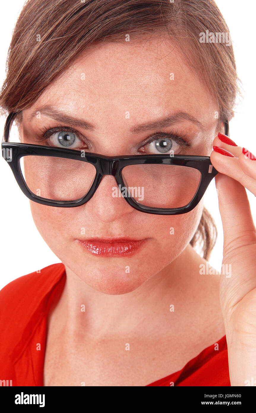 A beautiful young woman holding her black glasses, looking over the ...
