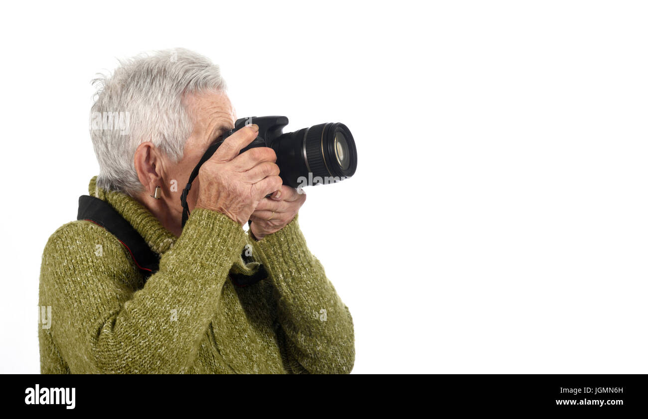 Senior woman shooting with a camera reflex Stock Photo - Alamy