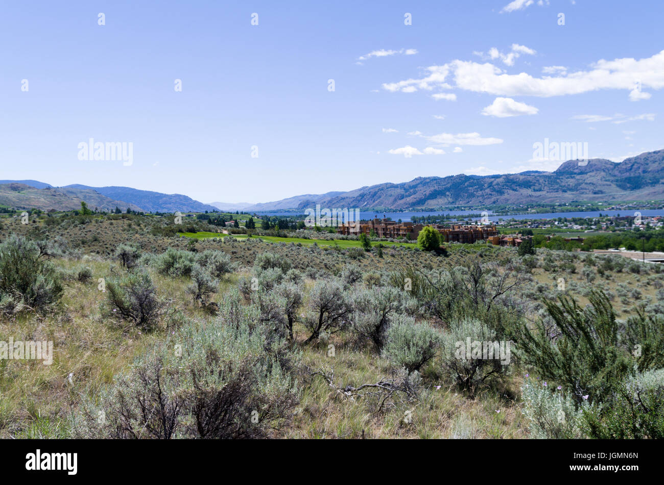 Desert landscape with Spirit Ridge resort buildings and Lake Osoyoos in ...