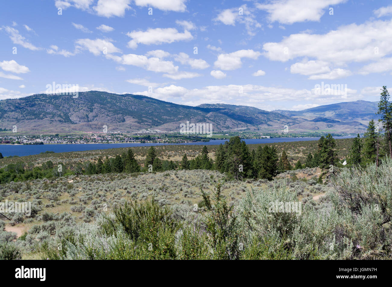 Desert landscape with Spirit Ridge resort buildings and Lake Osoyoos in ...