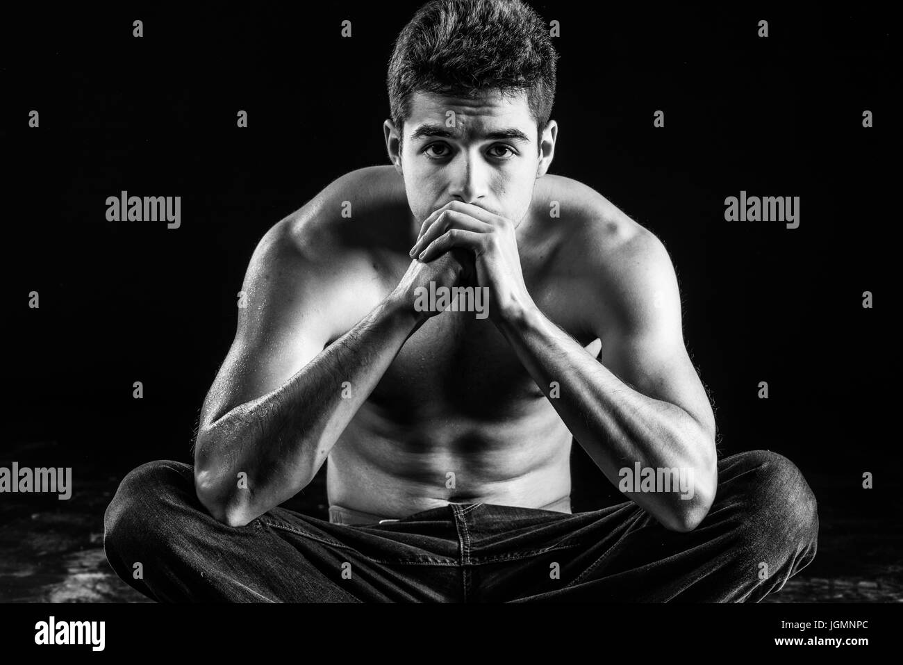 Shirtless muscular man staring into camera seriously Stock Photo - Alamy
