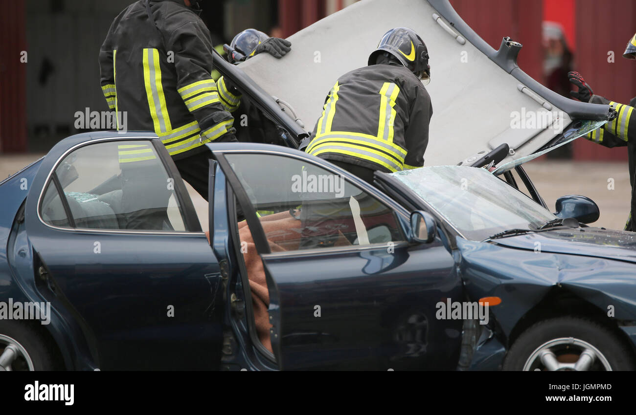 Firefighter team takes off the car roof to pull the wound after the car ...