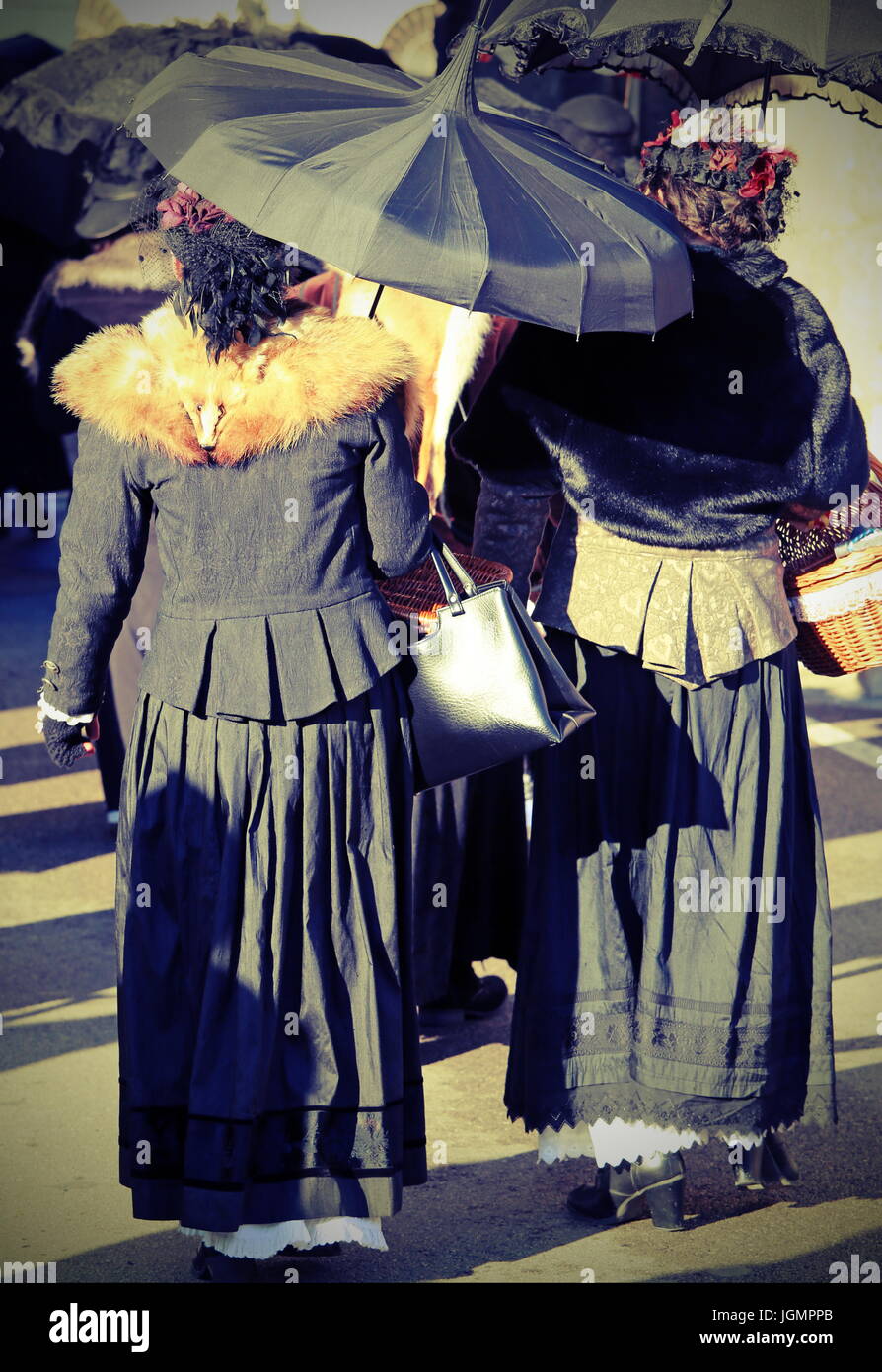 Old ladies dressed in vintage clothes and a black umbrella with vintage ...