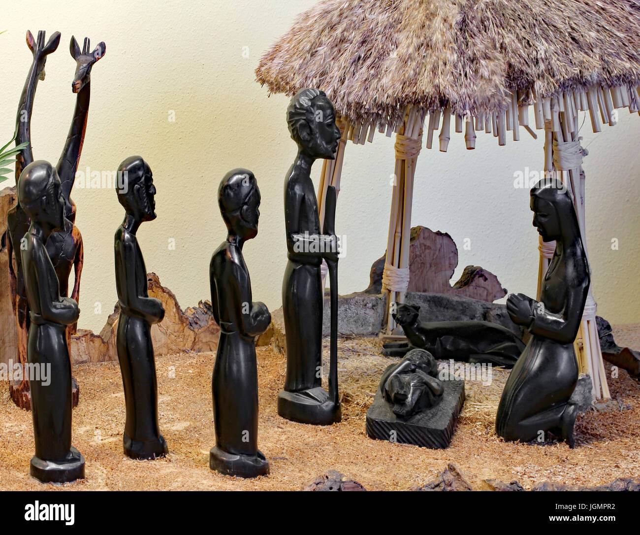 Nativity scene with the holy family, carved on the wooden black ...